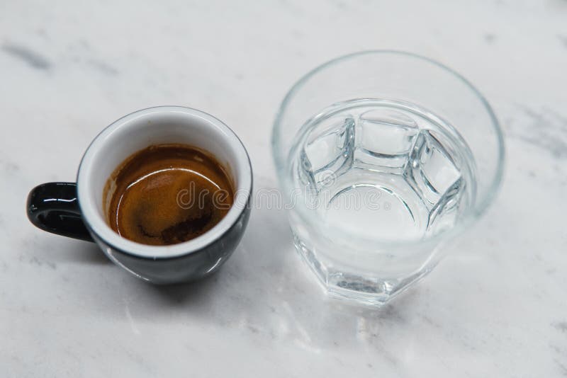Cup with Coffee Near a Glass of Water Stock Photo - Image of aroma ...