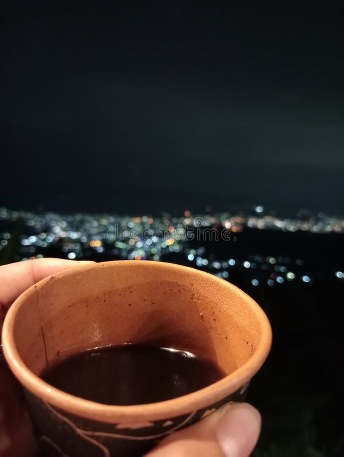 A Cup of Coffee at Night with the Beautiful City Lights Stock Photo ...