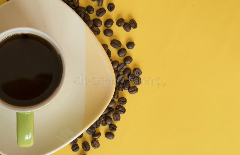 A Cup of Coffee Over the Yellow Ground and Coffee Beans Stock Image ...