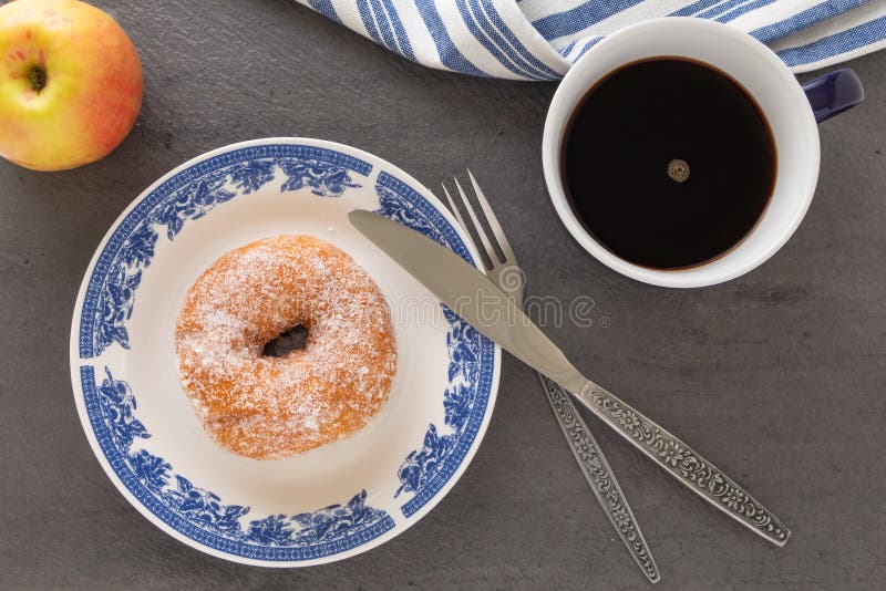 A Cup of Coffee, a Plate with Sugar Coated Doughnut and Other Breakfast ...