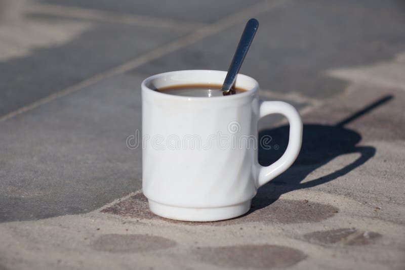 A Cup of Coffee on the Road. a White Cup with Black Coffee Stands on ...