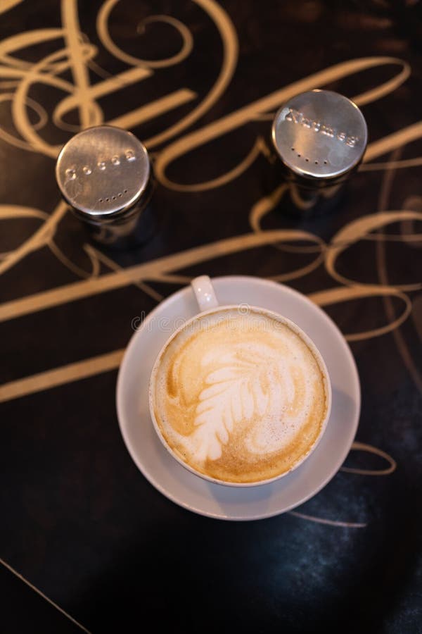 Cup of Coffee with Salt and Pepper Shaker on Table in Coffee Shop Cafe ...