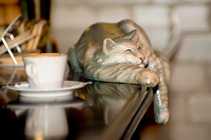 A Cup of Coffee and a Sculpture Lying Sleeping Cat Stock Photo - Image ...