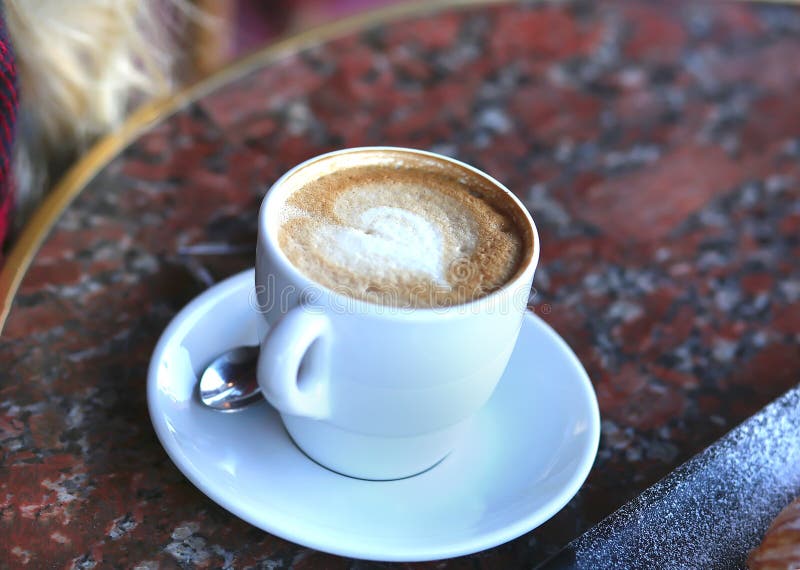 Cup of Coffee Stands on a Marble Table in a Cafe Stock Image - Image of ...