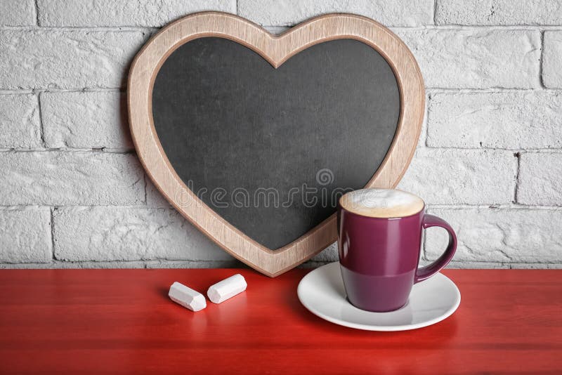 Cup of Coffee on Table Near Heart Shaped Stock Photo - Image of ...