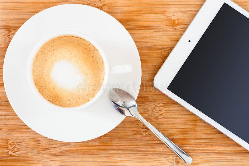 Cup of coffee with tablet stock photo. Image of closeup - 50934088