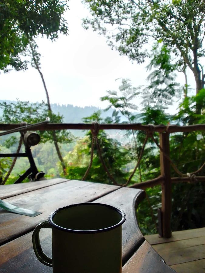 A Cup of Coffee with a View of Nature Behind Stock Image - Image of ...