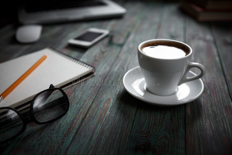 A Cup of Coffee in the Workplace on a Wooden Table Stock Photo - Image ...
