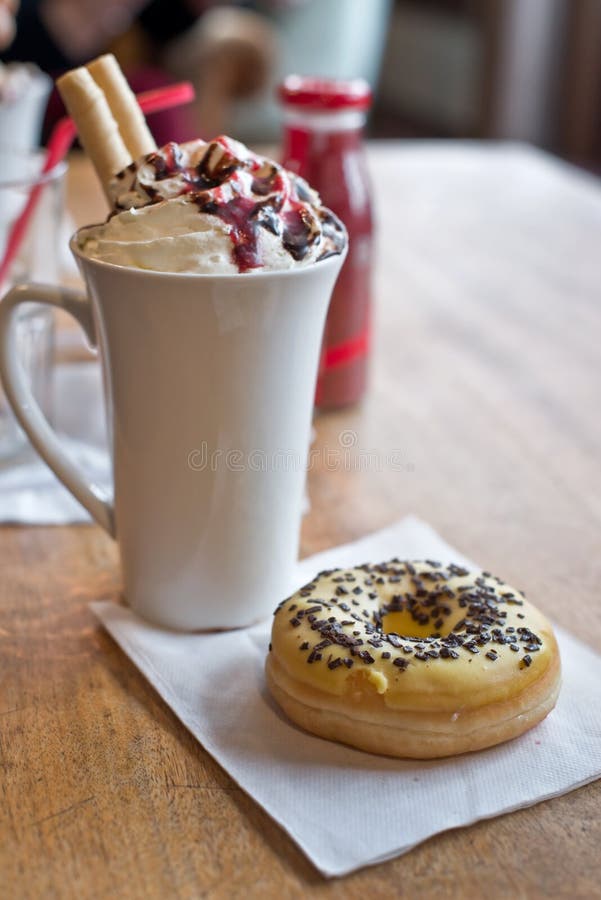 Cup with cream and donut stock photo. Image of restaurant - 56518314