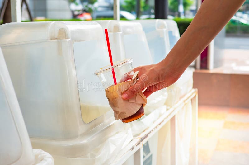 Hand Throwing Empty Plastic Bottle into the Recycling Bin. Disposal of ...