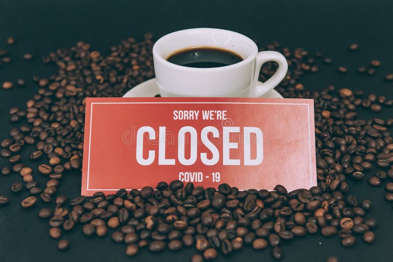 A Cup for Drinking and Sign Sorry we`re Closed COVID-19 on a Background ...