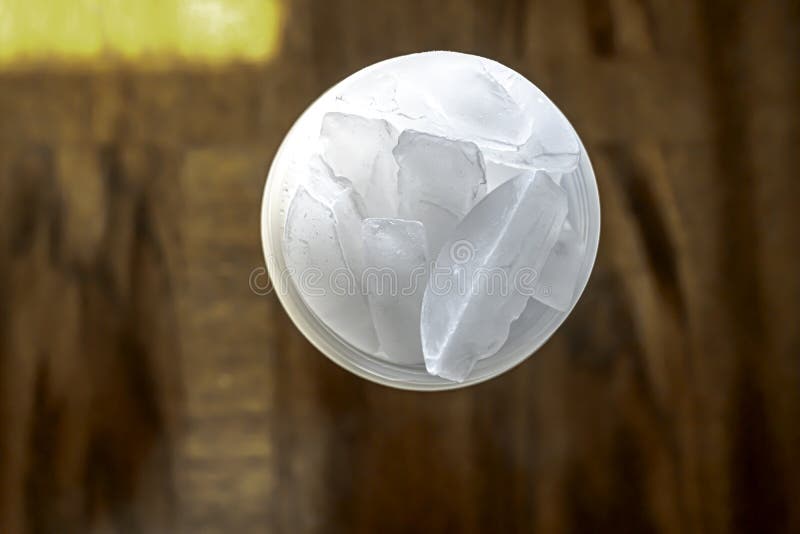 Cup Filled with Ice Cubes and Ice Chips on a Table Stock Photo - Image ...