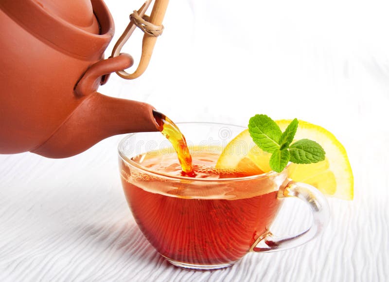 Cup of Fragrant Tea Flowing from a Teapot Stock Photo - Image of herb ...