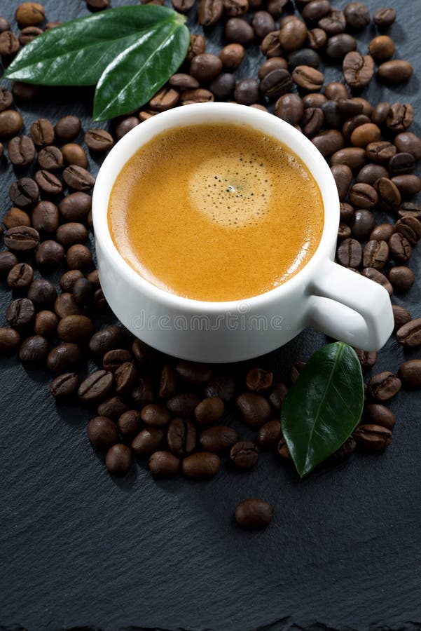 Cup of Fresh Espresso on Coffee Beans Background, Vertical Stock Image ...