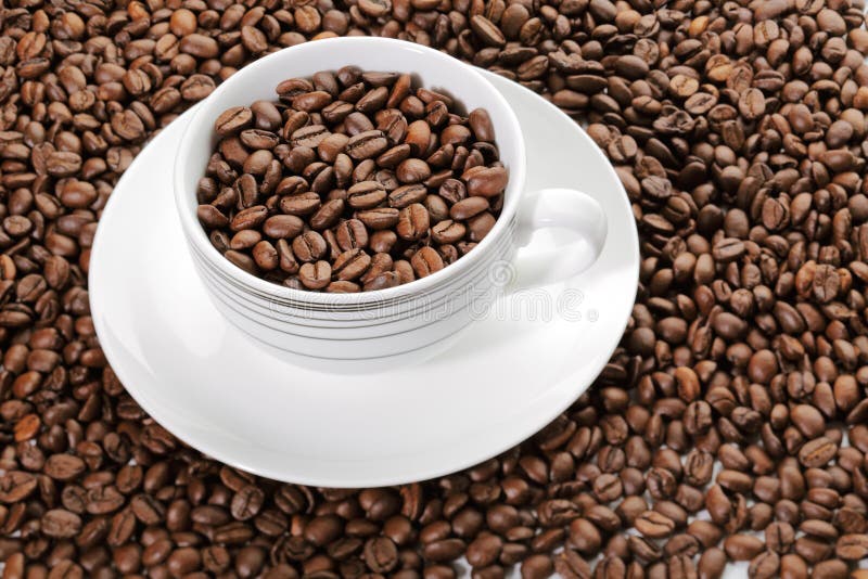 A Cup Full of Coffee Beans Surrounded by Coffee Beans Stock Photo ...