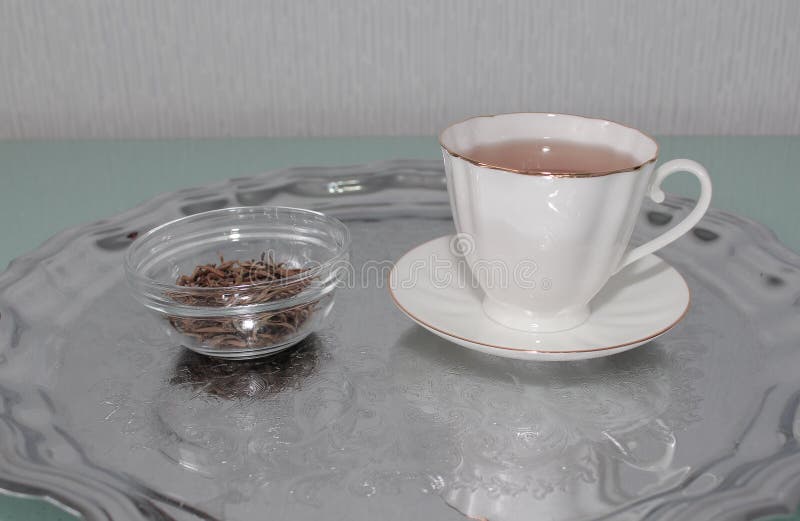 A Cup of Golden Tea and Its Leaves Stock Photo - Image of herb, tray ...