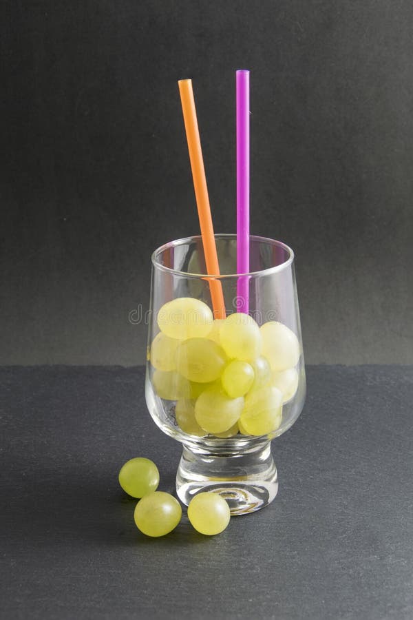 Cup with grapes and reeds. stock image. Image of gather - 169098971