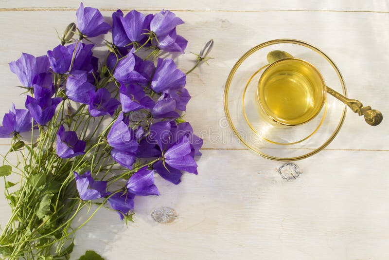 Cup of Green Tea in a Glass Cup and a Bouquet of Bells Stock Image ...