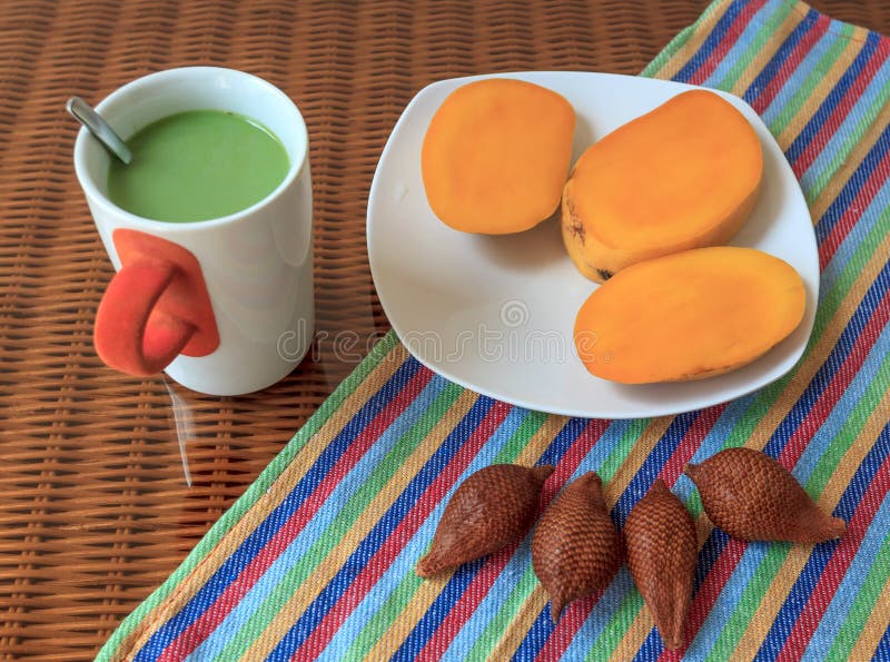 Cup of Green Tea with Tropical Fruits on a Glass Surface Stock Image ...