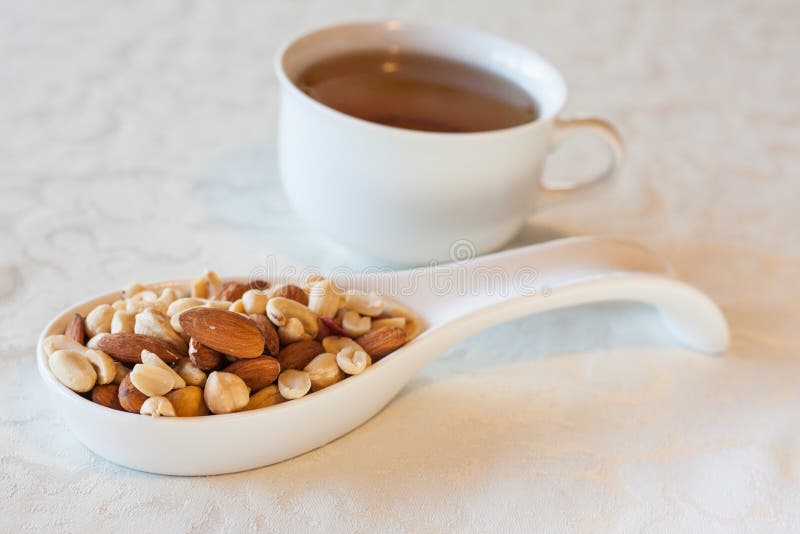 A Cup of Green Tea and Variety of Nuts Stock Photo - Image of almond ...