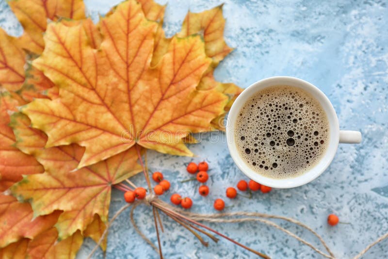 Cup of Hot Coffee with Autumn Leaves on Color Table Stock Photo - Image ...