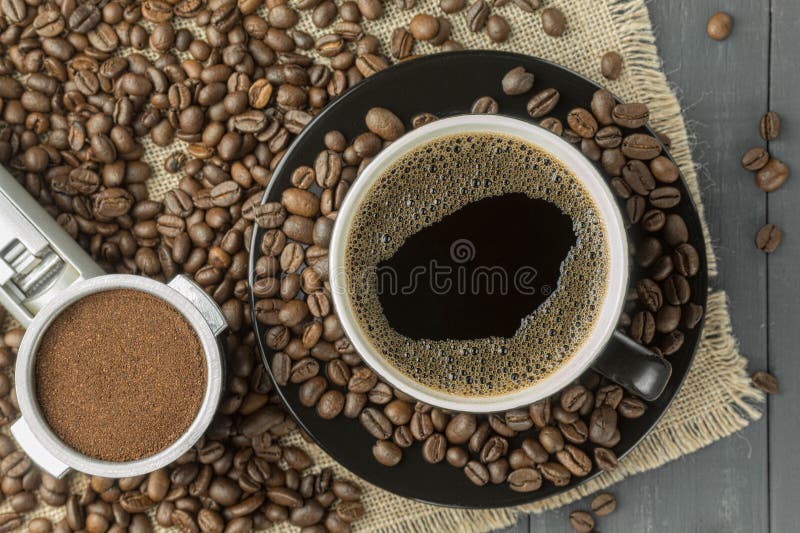 Cup with Hot Coffee on the Background of Grains and Ground Coffee Stock ...