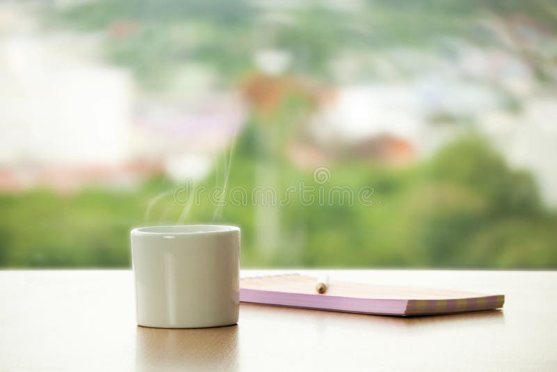 Cup of Hot Coffee with Pencil and Note Book on the Table in Cafe Stock ...