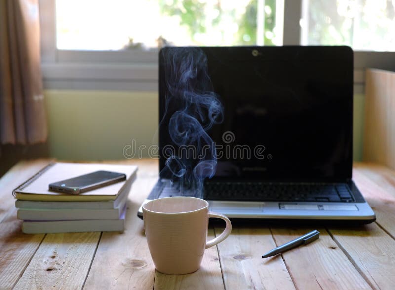 A Cup of Hot Coffee Smoke and a Book, Computer on Wood Table Stock ...