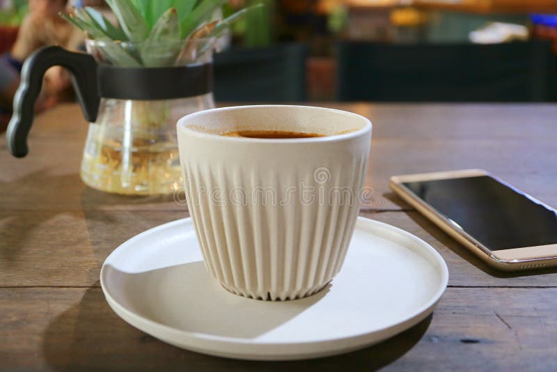 Cup of Hot Coffee on a Wooden Table with Blank Screen Smartphone in ...