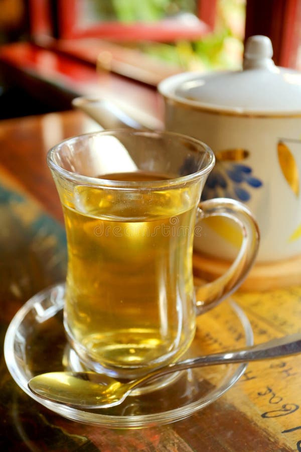 Cup of Hot Herbal Tea in Transparent Cup with a Teapot Stock Image ...