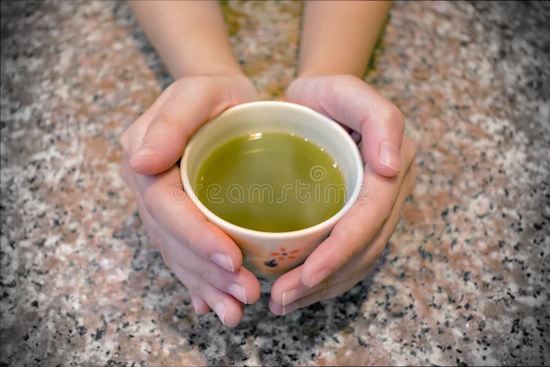 Cup of Hot Japanese Green Tea in the Palms of Both Hands. Stock Image ...