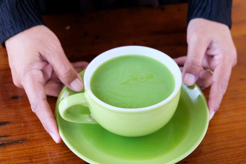 A Cup of Hot Milk Green Tea in Hands N the Table Stock Image - Image of ...