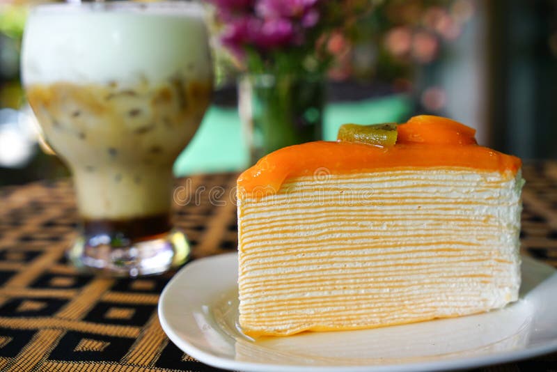 Cup Iced Coffee with Orange Crape Cake on the Table Stock Image - Image ...