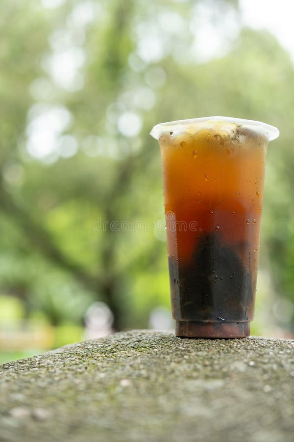 Cup of Iced Tea with Brown Sugar in the Outdoor Vertical Composition ...