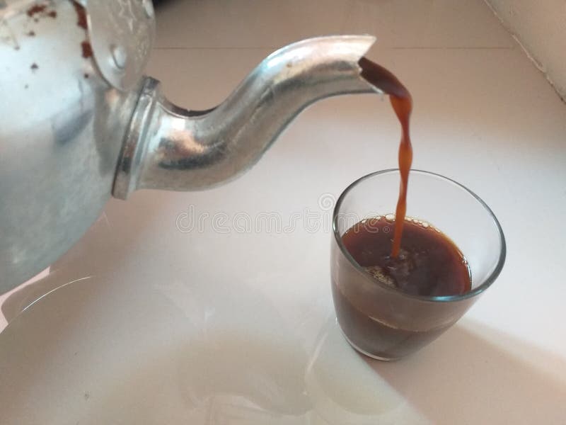 A Cup of Javanese Coffee that is Poured from a Kettle Stock Image ...