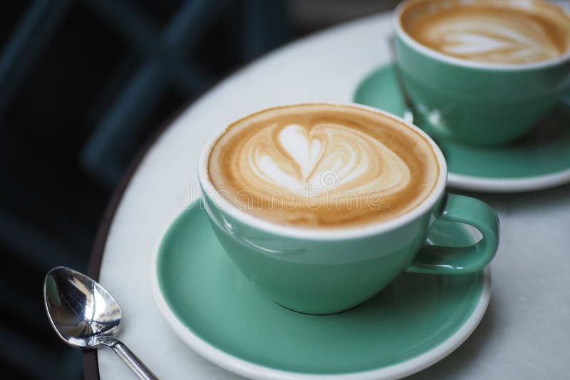 A Cup of Late Coffee with Flower Shape Design on Top at Cafe Stock ...