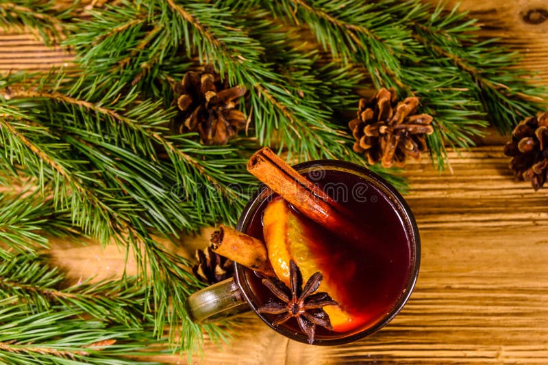 Cup of Mulled Wine with Cinnamon and Fir Tree Branches on Wooden Table ...
