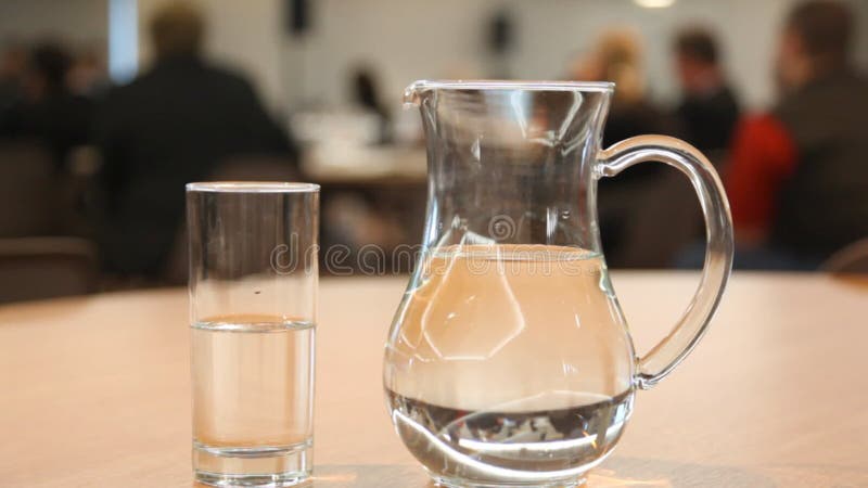 Cup and Pitcher Filled with Water Stand on Table Stock Video - Video of ...
