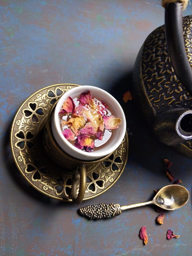 A Cup of Rose Tea with a Metal Tea Pot Stock Photo - Image of petal ...