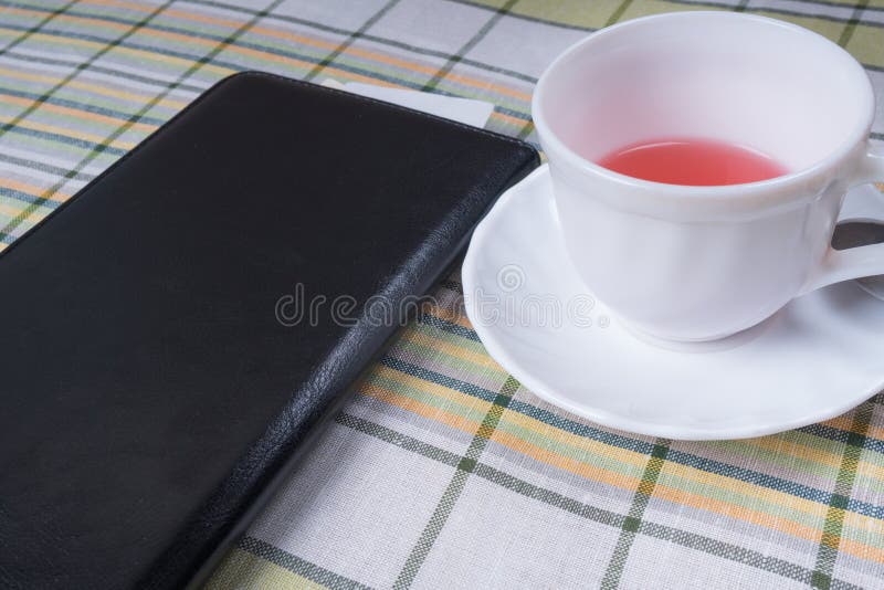 Cup of Tea and a Black Folder with the Bill for Payment Stock Photo ...