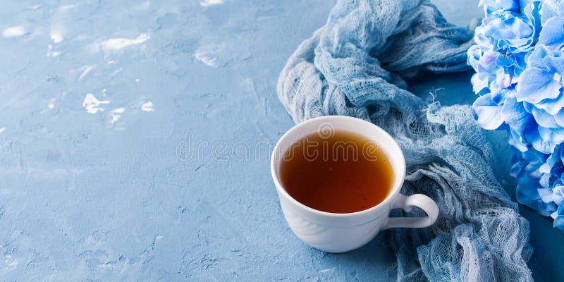 Cup of Tea on Blue Background with Flowers Stock Image - Image of ...