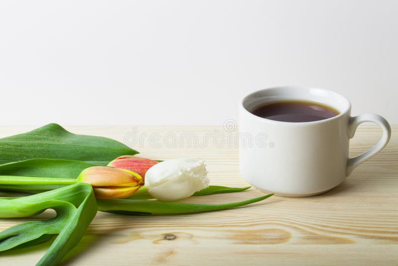 Cup of Tea and Bunch of Spring Tulips on the Table. Toned Stock Photo ...