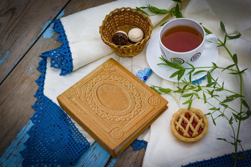 Cup of tea, cake and book stock photo. Image of energy - 94530164