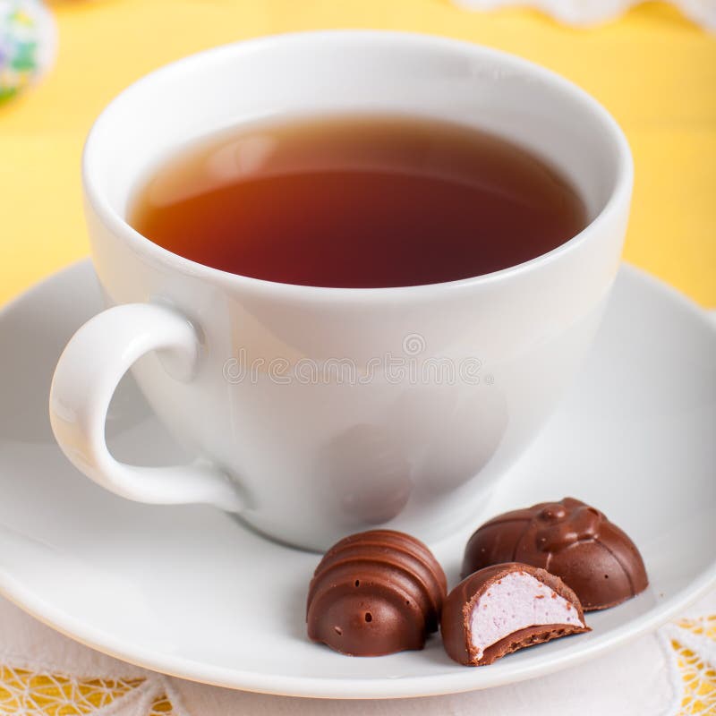 A Cup of Tea with Easter Egg Shaped Chocolate Candies Stock Photo ...