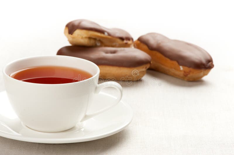 Cup of tea and eclairs stock photo. Image of sweets, frosting - 39913950