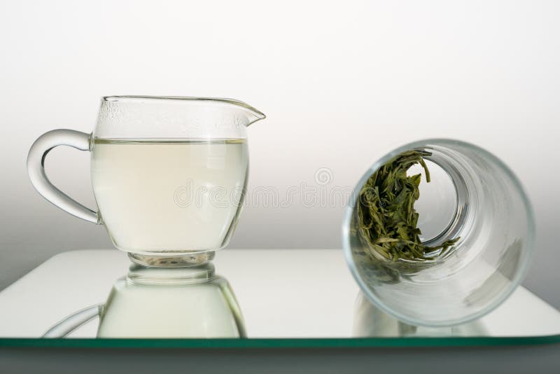 Cup of Tea and Glass with Tea Leaves with Reflection Stock Image ...