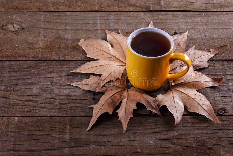 Cup of Tea and Leaves Over Rustic Wooden Background Stock Photo - Image ...