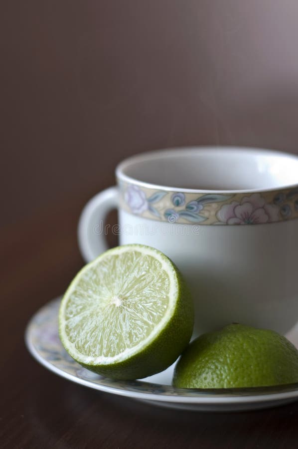 Cup of tea with lime stock image. Image of elegance, ceramic - 12370537