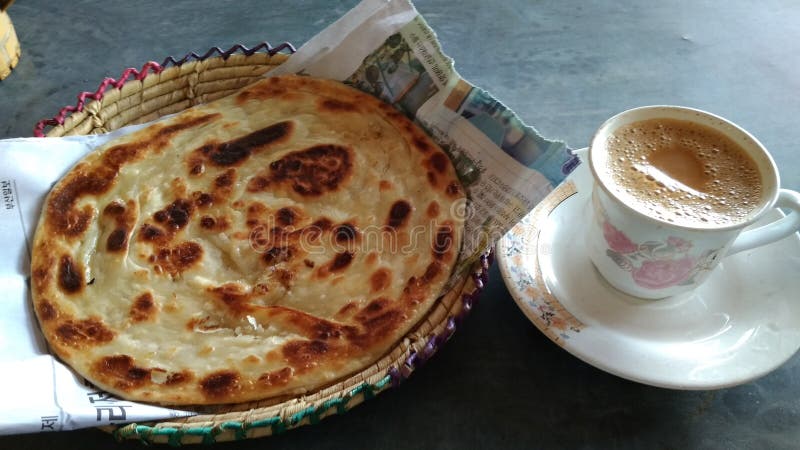 A cup of tea and Paratha stock image. Image of table - 132544291