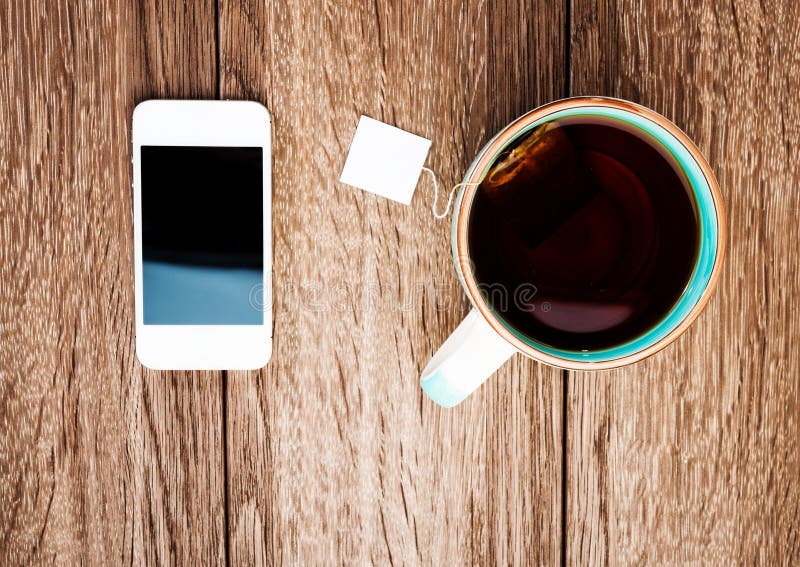 Cup of tea and phone stock image. Image of modern, break - 52130915